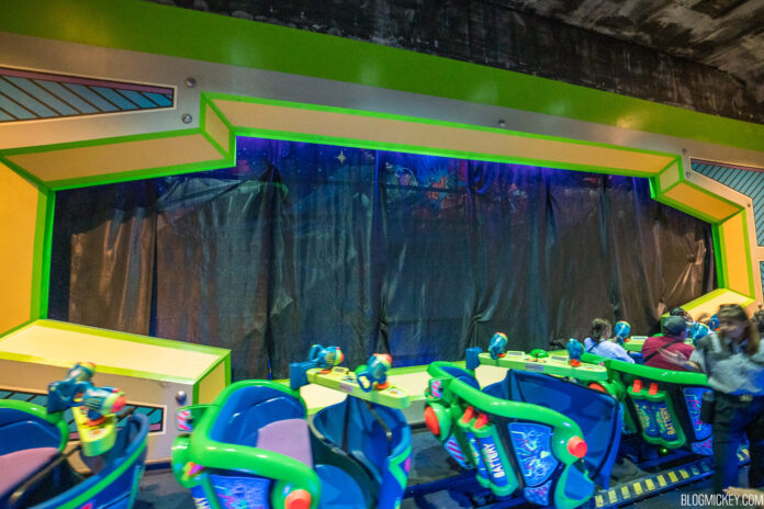 Buzz Lightyear's Space Ranger Spin Ride Mural Behind Tarp at Magic Kingdom